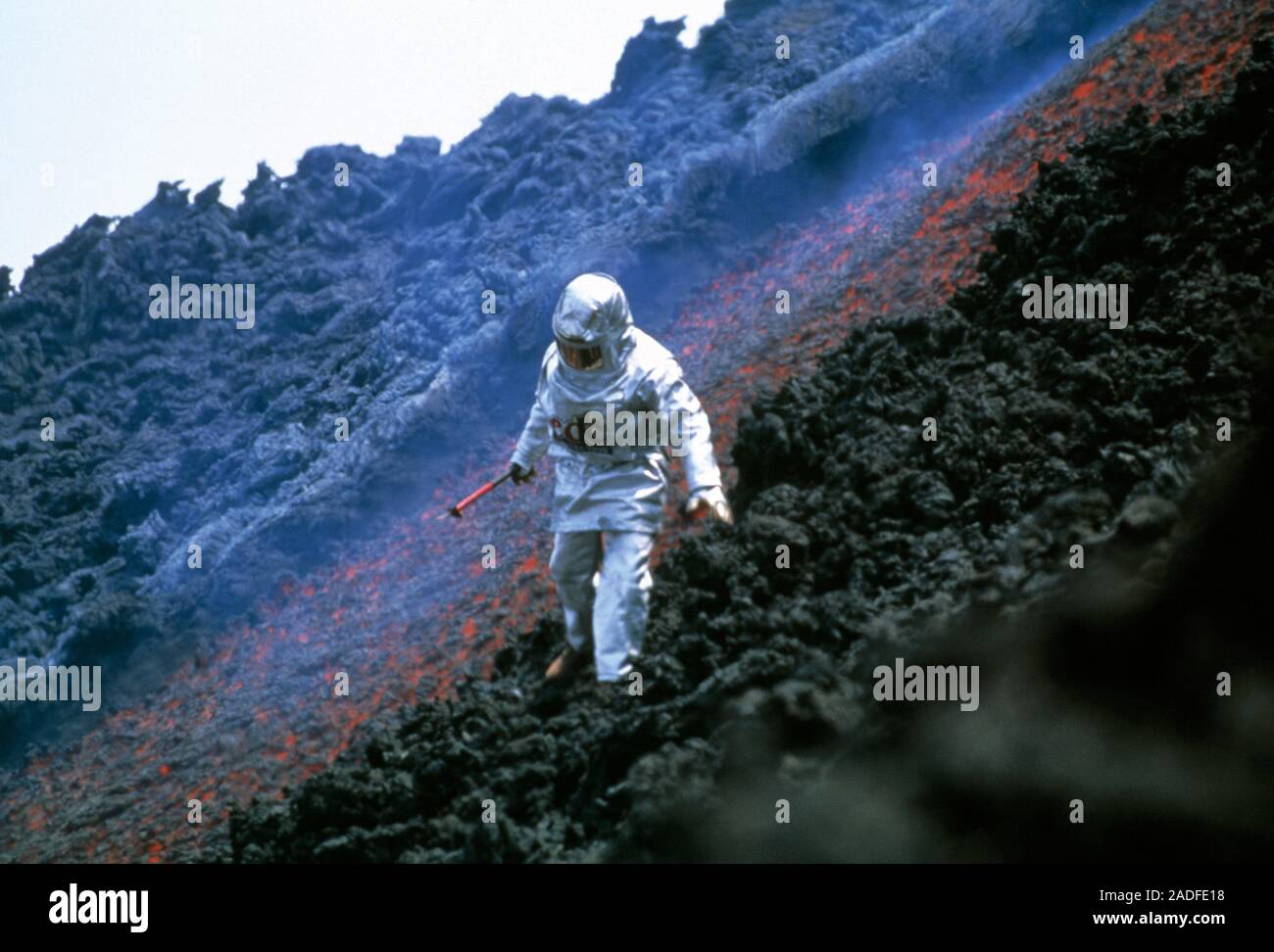 Volcanologist wearing a heat suit while climbing on solidified lava ...