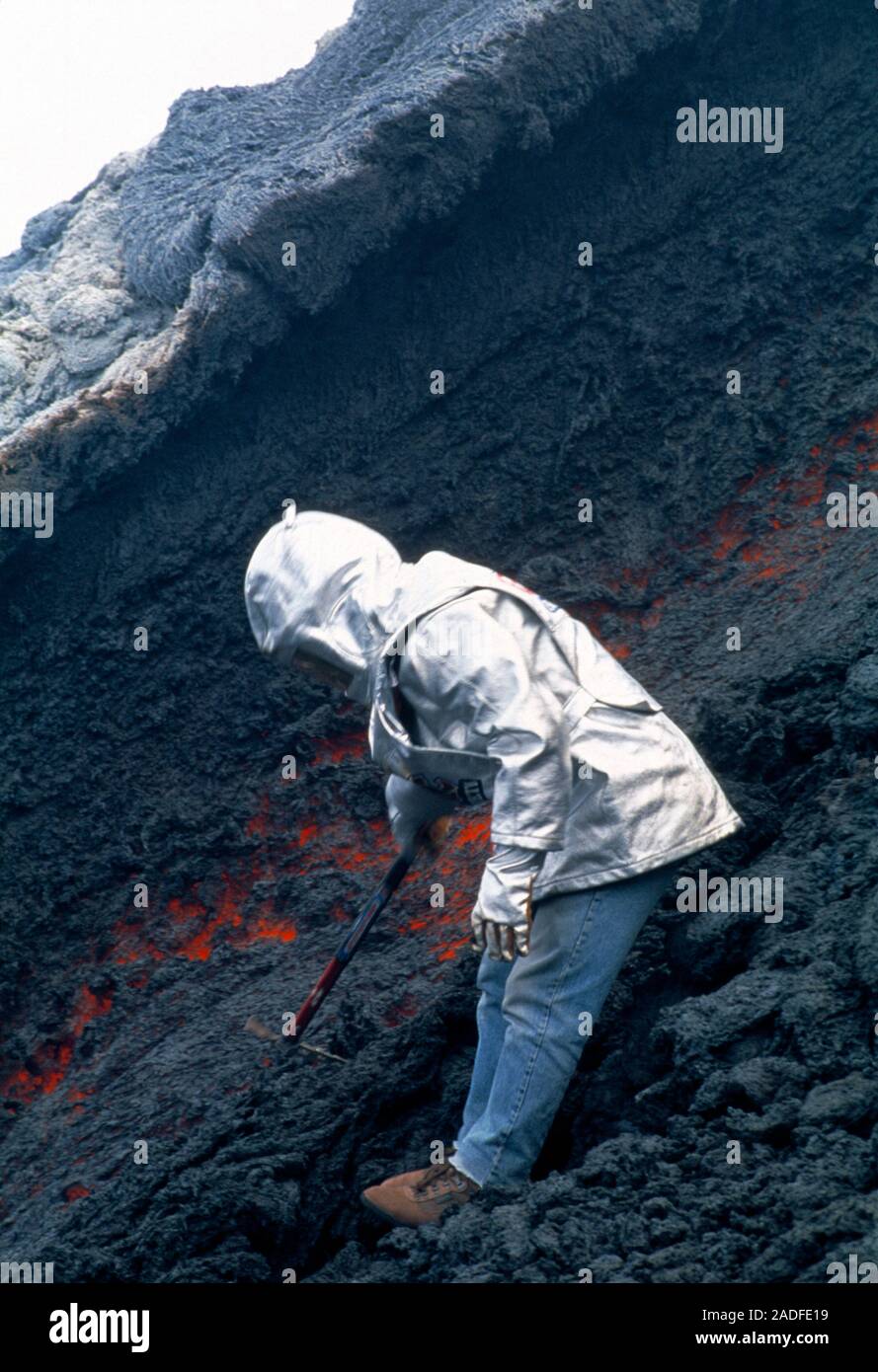 Volcanologist wearing a heat suit while climbing on solidified lava ...