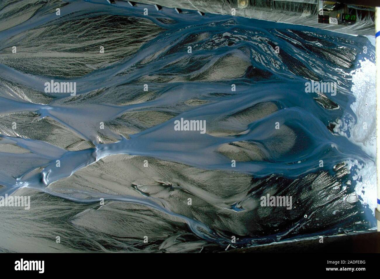 Geological research tank. Braided streams flowing over sediment to the ...