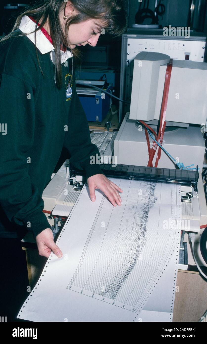 Seismic profile. Geologist on a research ship printing out a seismic ...