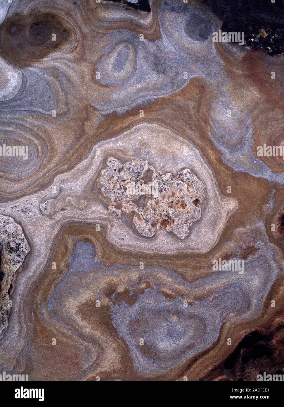 Sandstone rock strata. Patterns in crumpled strata revealed in eroded ...