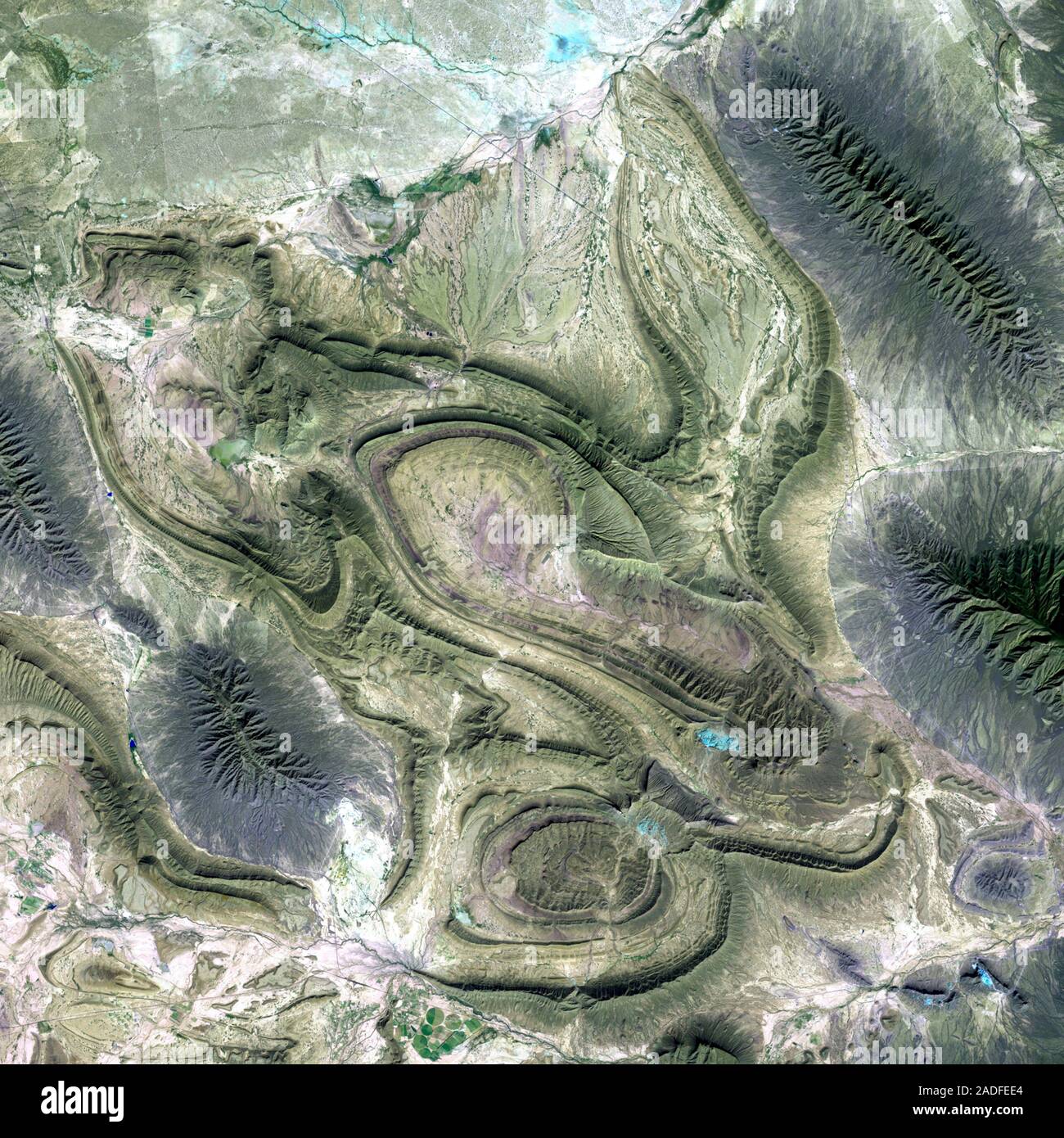 Eroded mountains, satellite image. Ridges of rock (green) and heavily ...