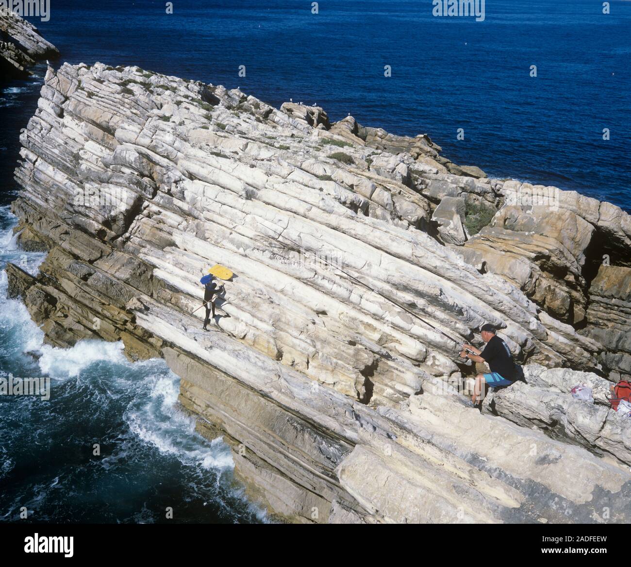 Rock strata revealed in eroded coastal rocks. The diagonal strata seen ...
