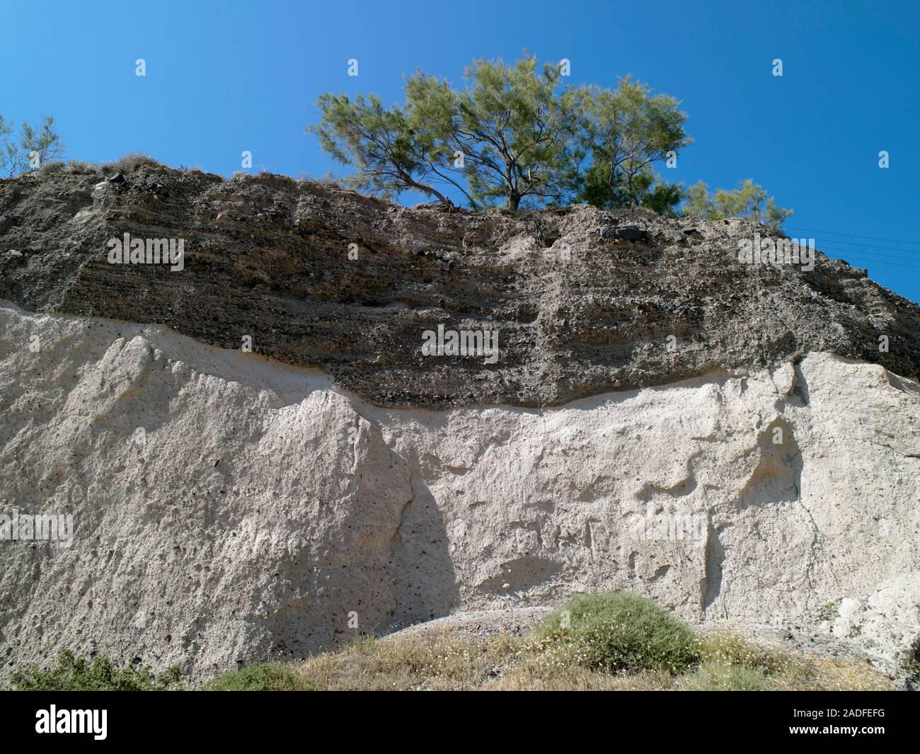 Santorini volcanic rock strata. The strata are a result of successive ...