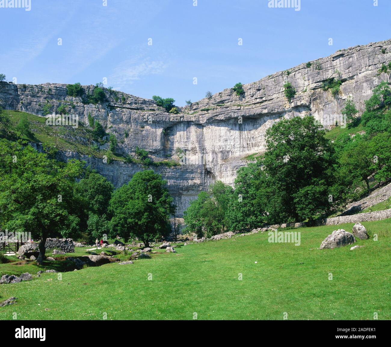 Limestone cliff. Limestone cliff overlooking a path used by leisure ...