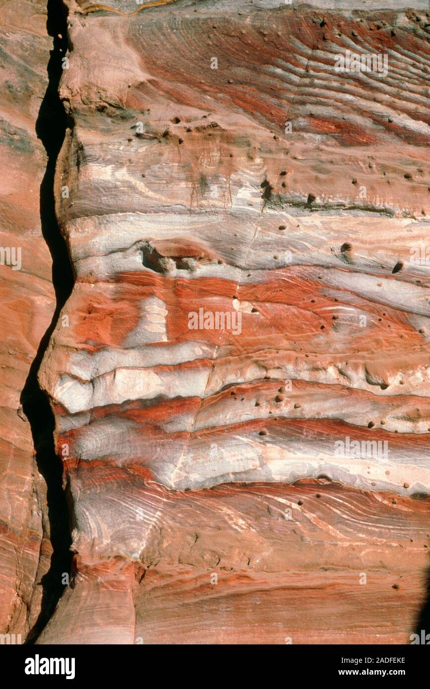 Banded sandstone. View of the face of a sandstone rock wall showing the ...