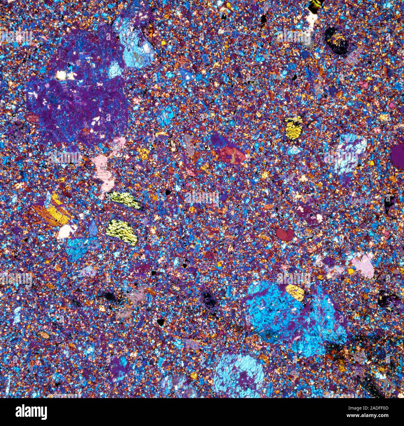 Polarised light micrograph of a thin section of basalt, an igneous rock ...