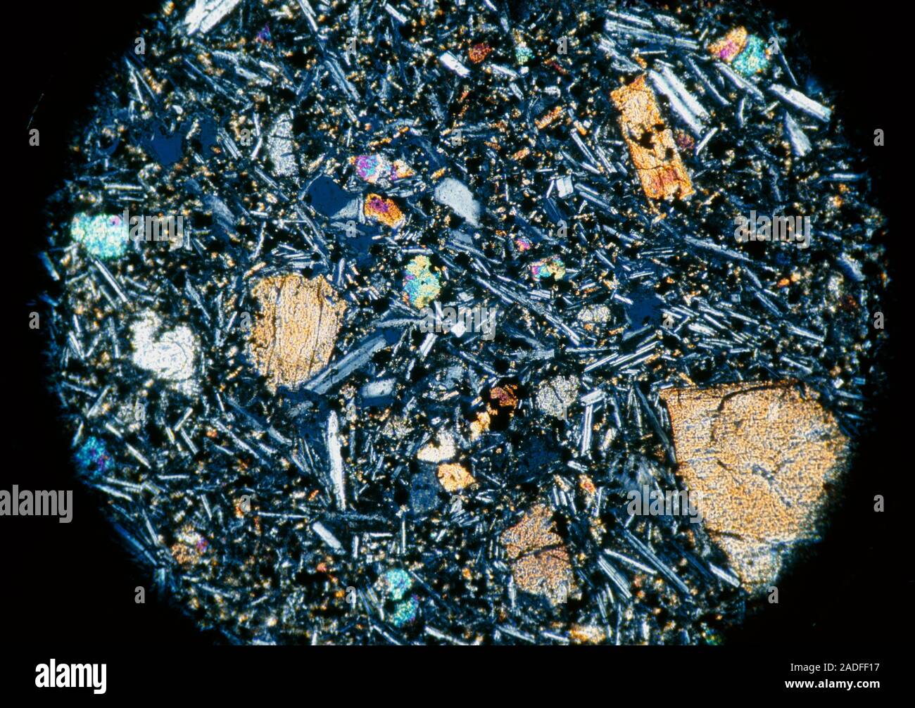 Polarised light micrograph of a thin section of basalt, a fine-grained ...