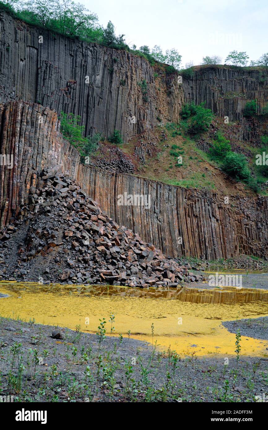 Columnar basalt rock in a disused quarry. Pentagonal or hexagonal ...