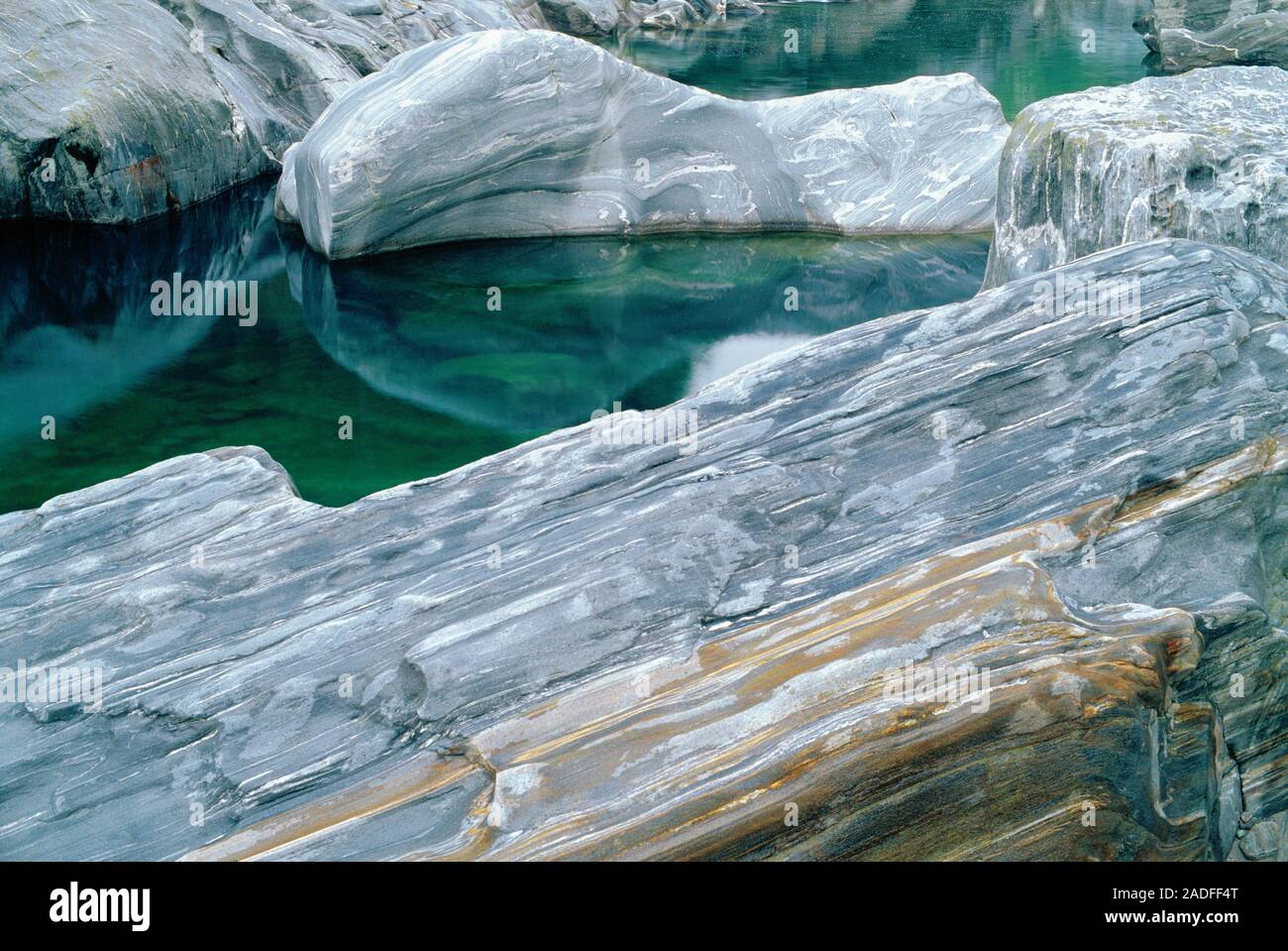 Gneiss boulders in a river. Gneiss is formed from other types of rock ...