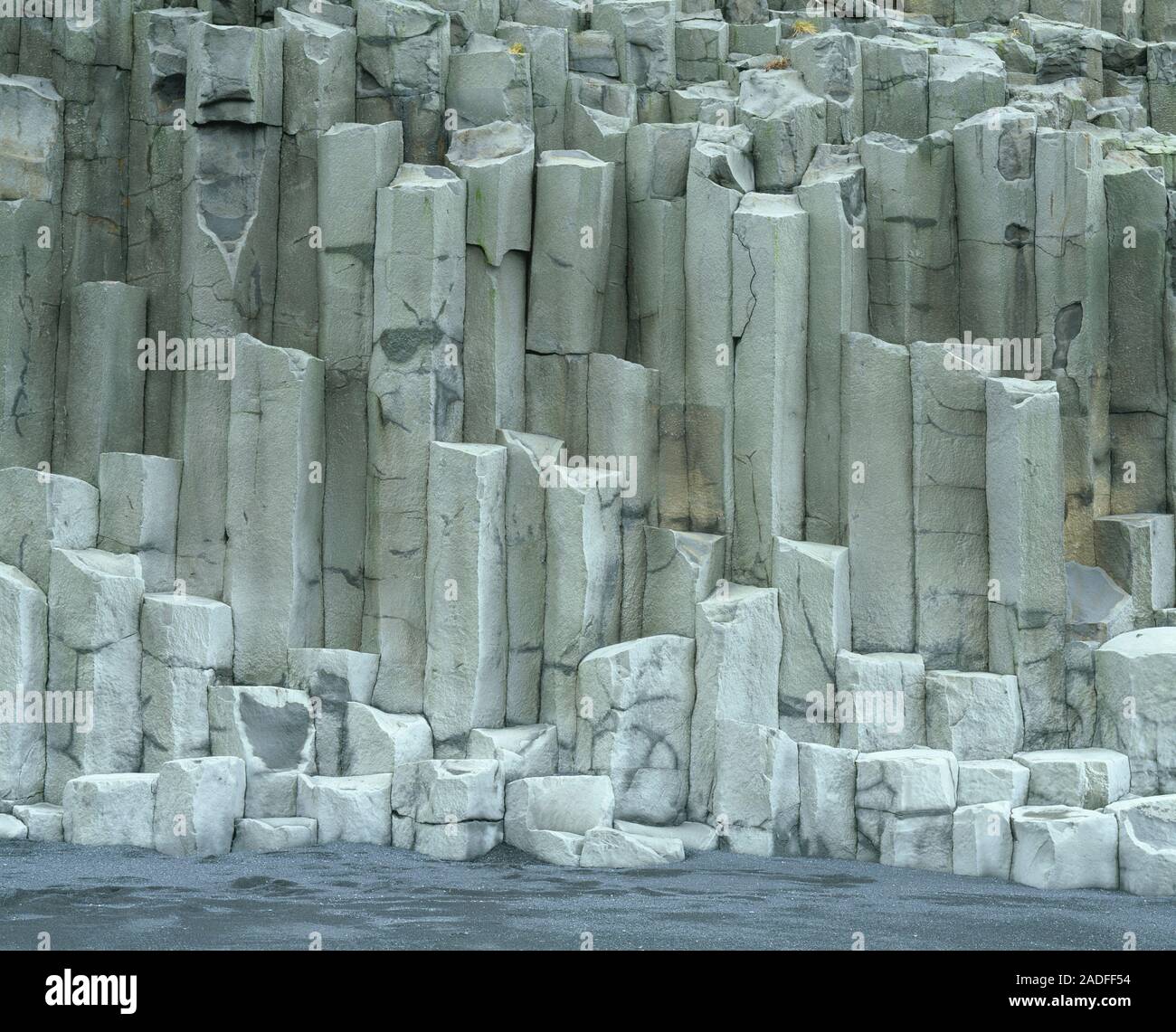 Basalt columns. Columns of basalt by a black sand beach. Basalt is an ...