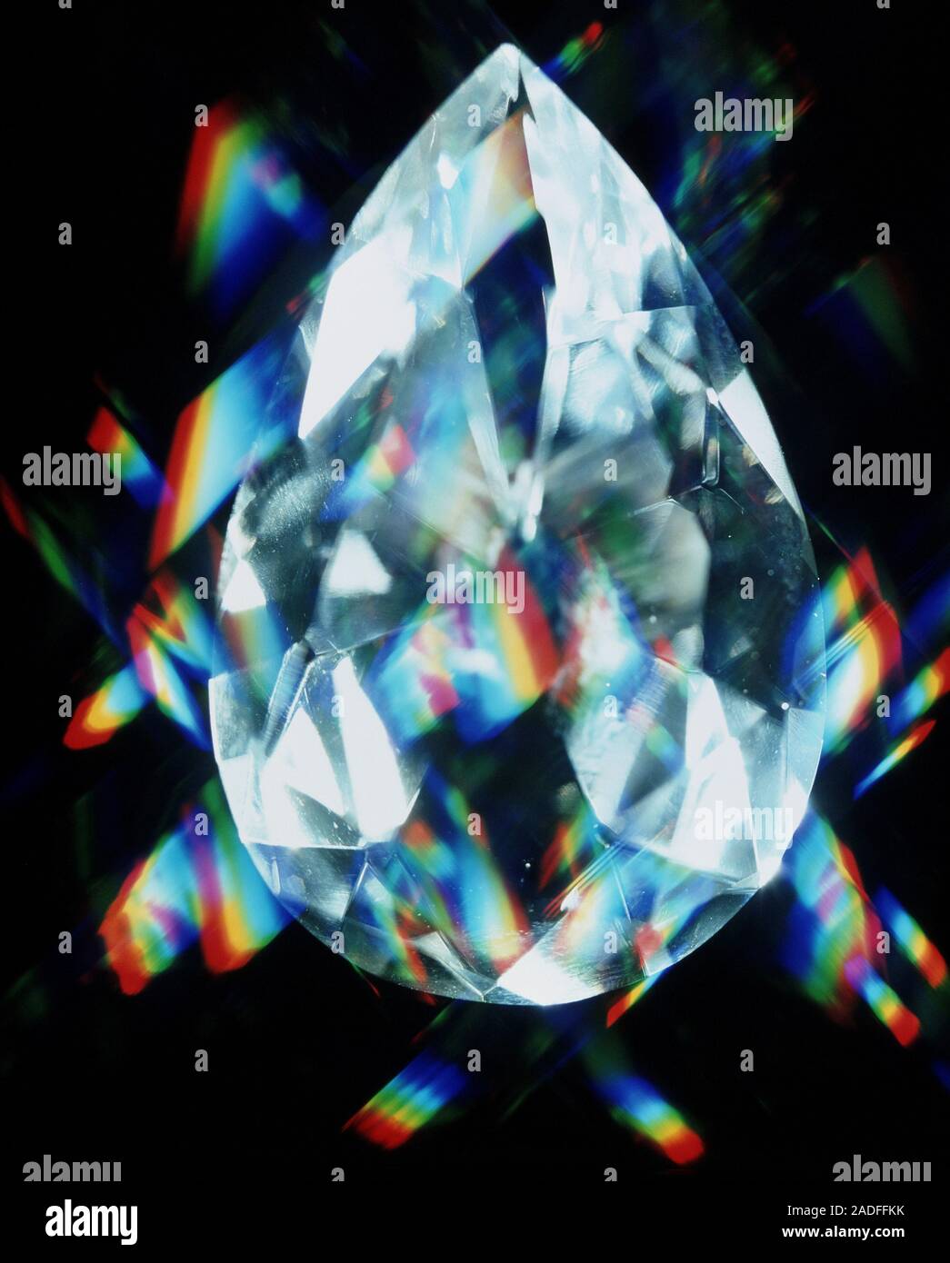 Diamond. Macrophotograph of a cut diamond. The colours result from a ...