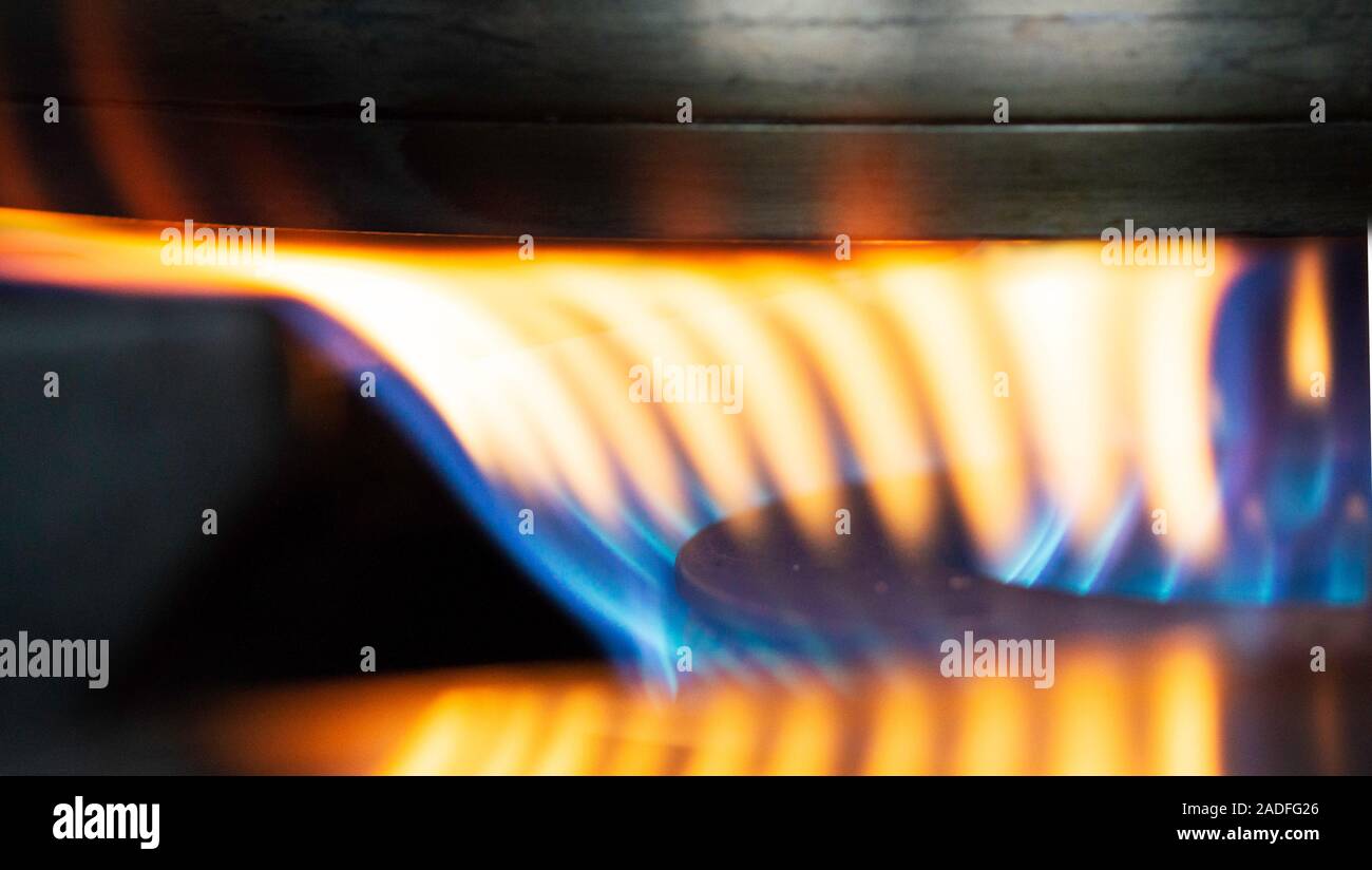 A Macro Image of a Blurry Blue and Yellow Flames on Gas Stove Burner ...