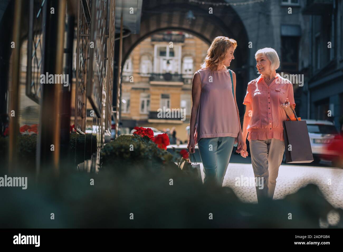 Two women talking while walking stock photo Stock Photo - Alamy