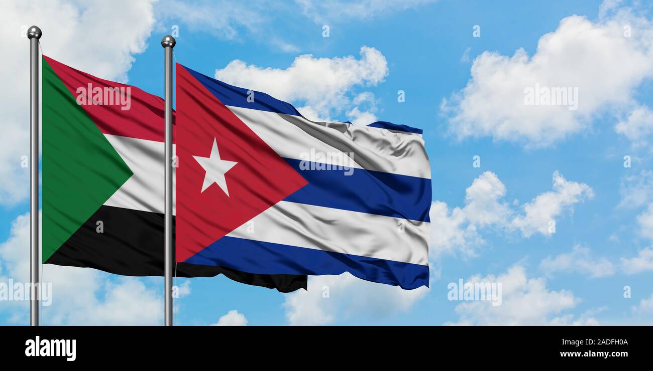 Sudan and Cuba flag waving in the wind against white cloudy blue sky ...