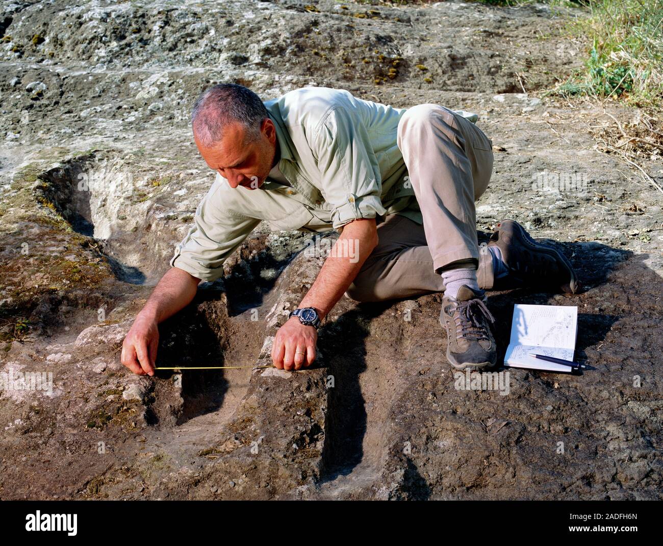 Homo erectus tracks. The palaeont- ologist Dr. Marco Avanzini measuring ...