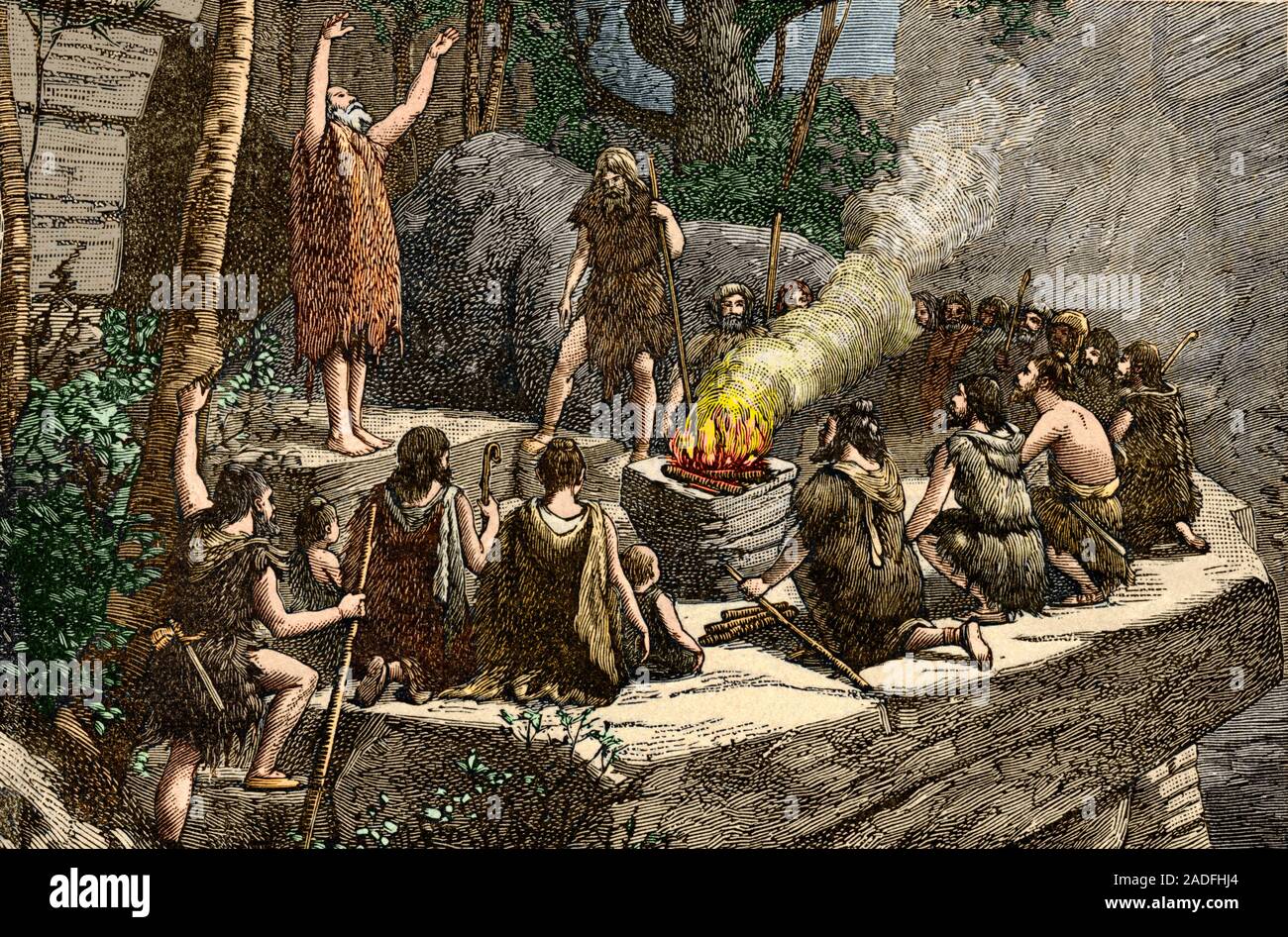 Early use of fire. Historical artwork of early humans gathered around a ...