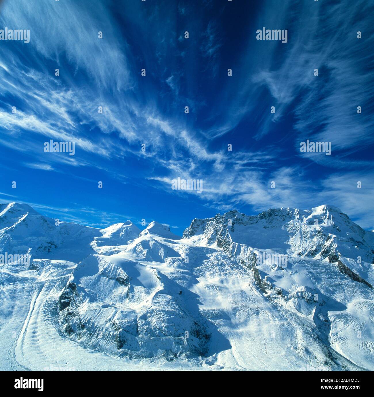 Alps. Mountains in the Alps, covered in snow. Clouds of ice crystals ...