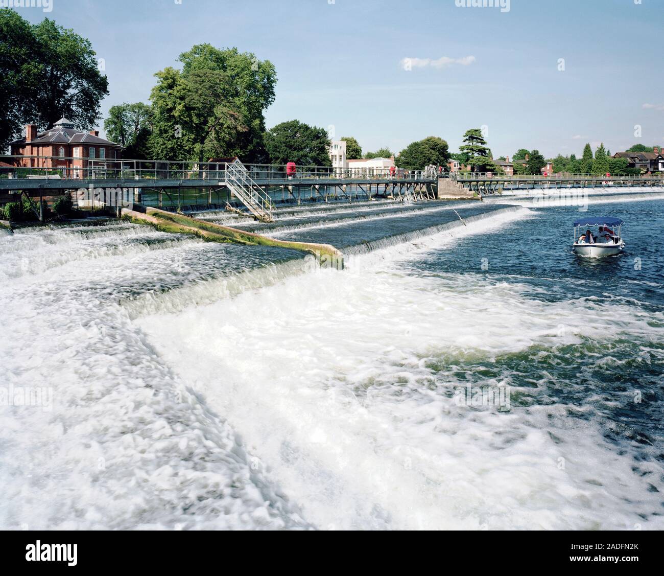 Marlow Weir. The weir is at left, with water flowing over it from left ...