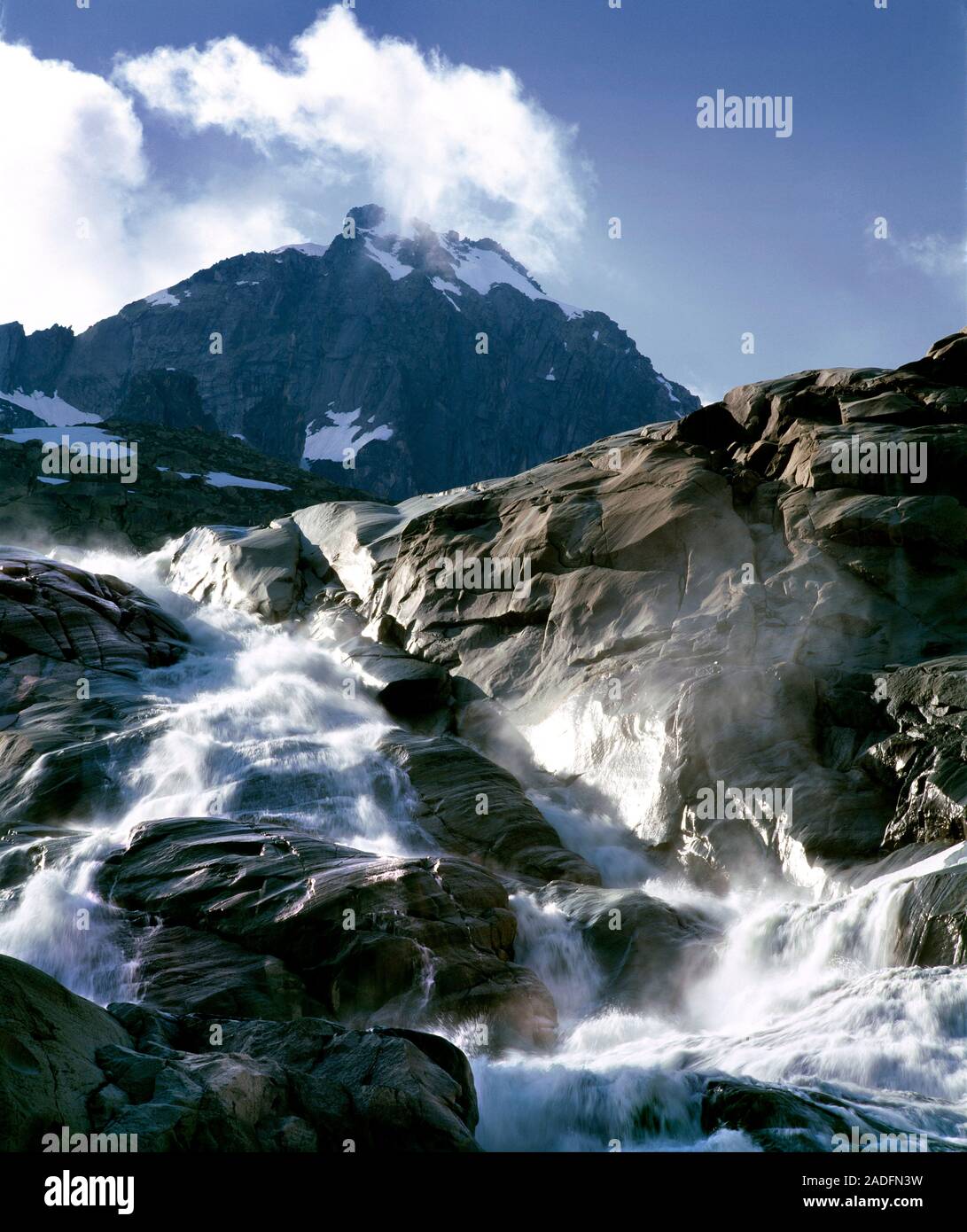 Mountain stream cascading beneath a mountain summit. Photographed in ...