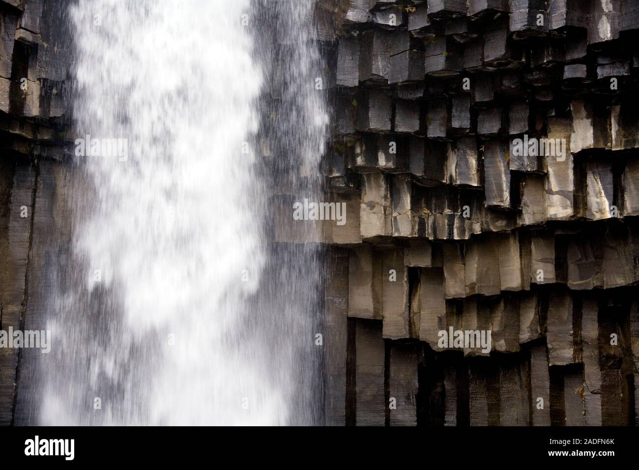Waterfall and basalt rock. Waterfall flowing over close-packed ...