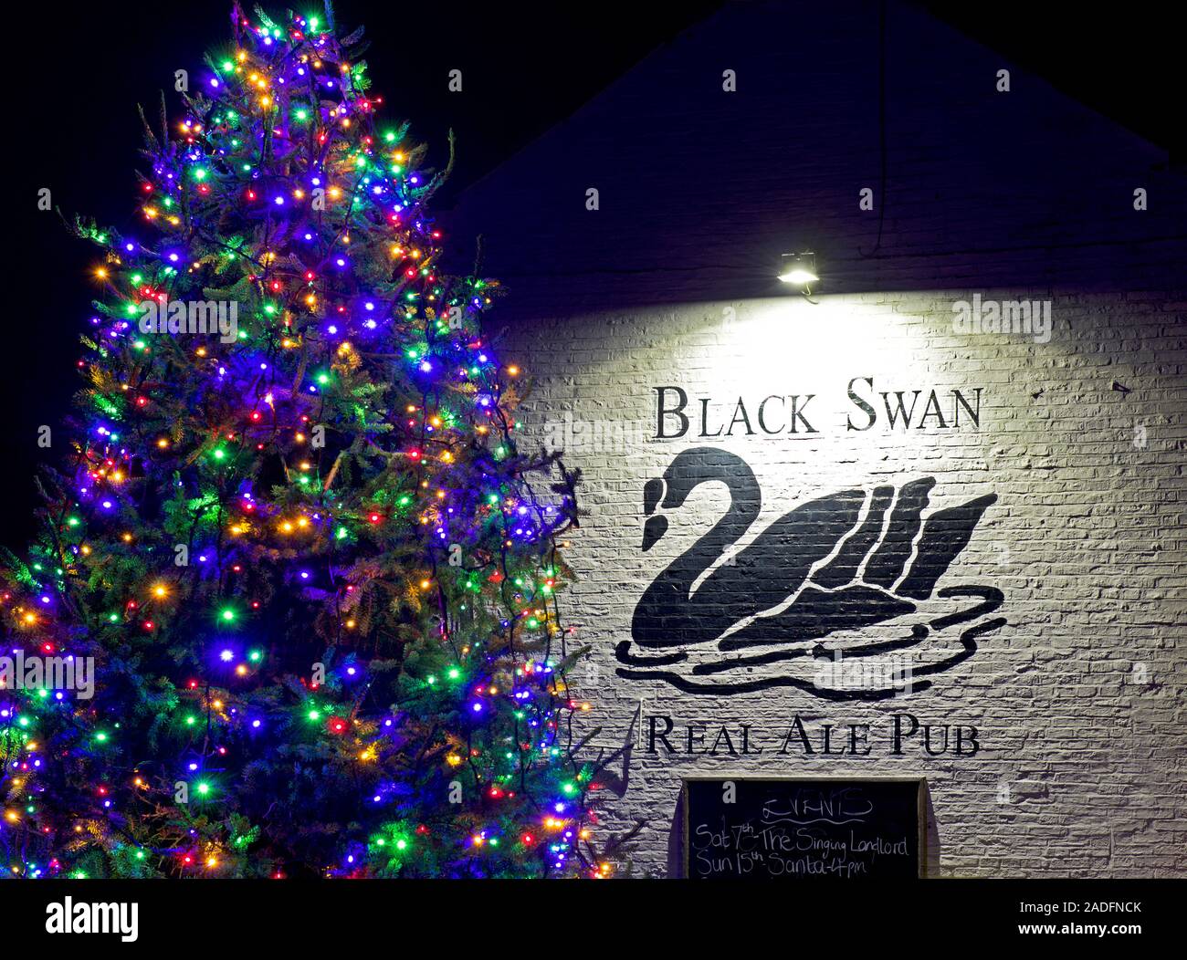 The Black Swan pub at twilight, in the village of Asselby, East ...