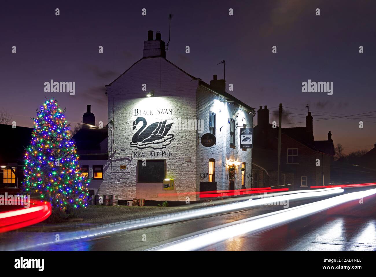 The Black Swan pub at twilight, in the village of Asselby, East ...