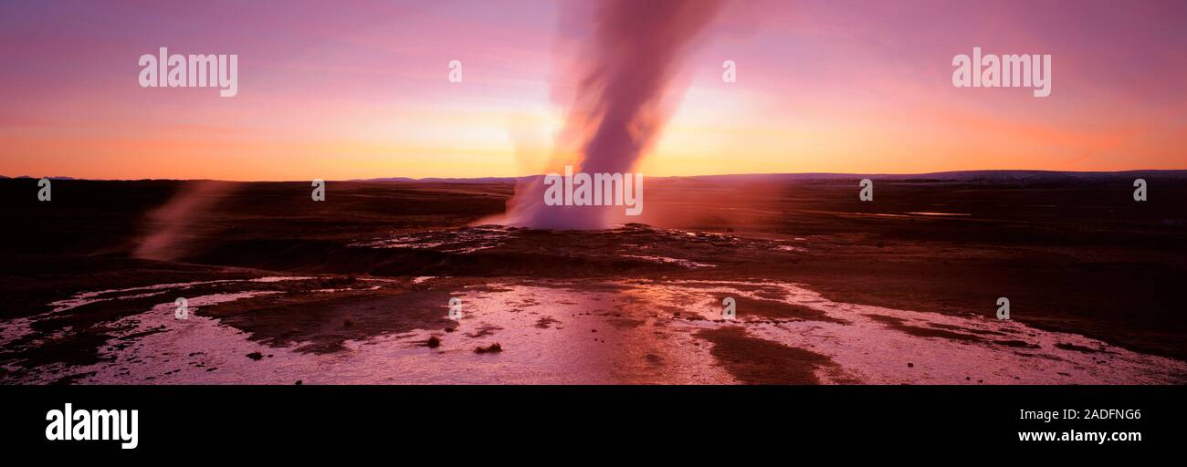 Geyser erupting at sunset. A geyser is a deep natural well in a ...