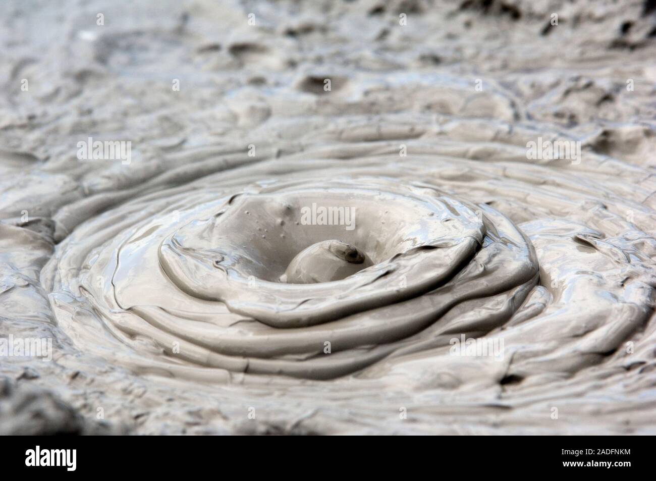 Geothermal mud pool. Eruption of volcanic gases from a mud pool in a ...