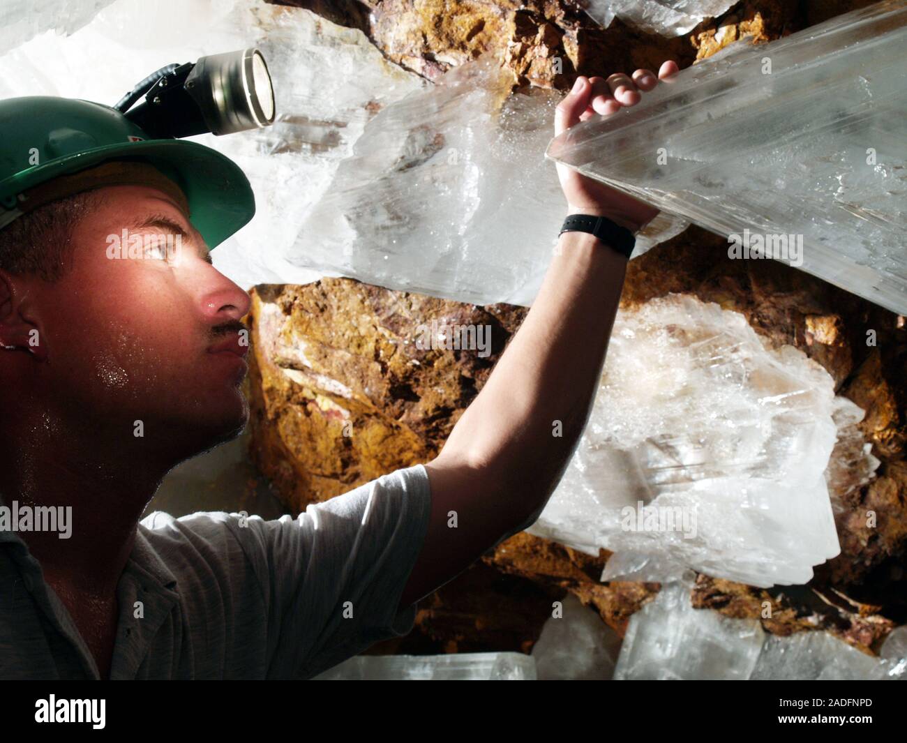 Cave of Crystals. Geologist touching a selenite crystal in the Cave of ...