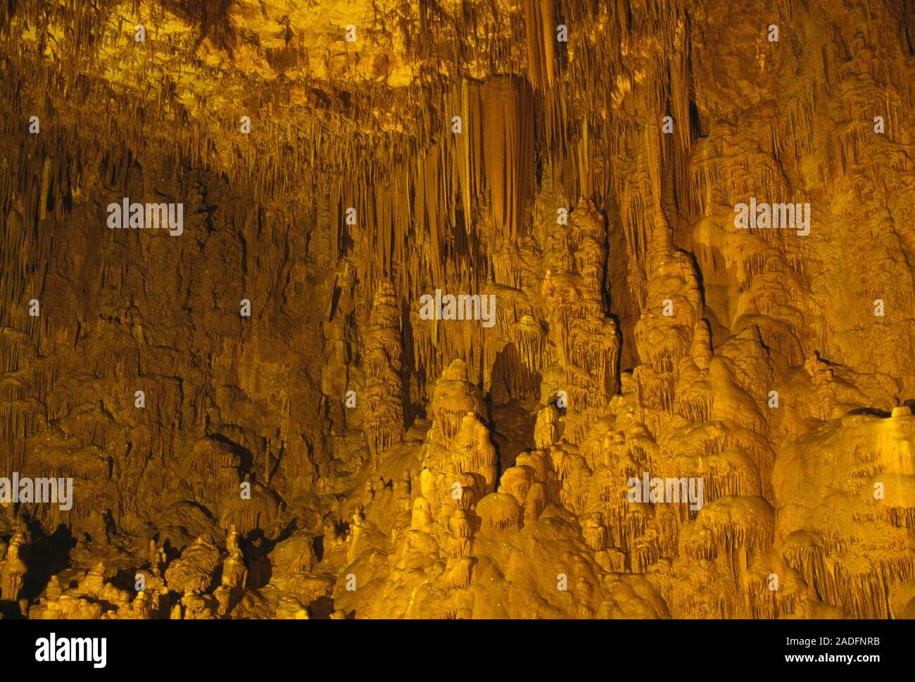 Stalactites and stalagmites in a cave. Stalactites (pointed, upper ...