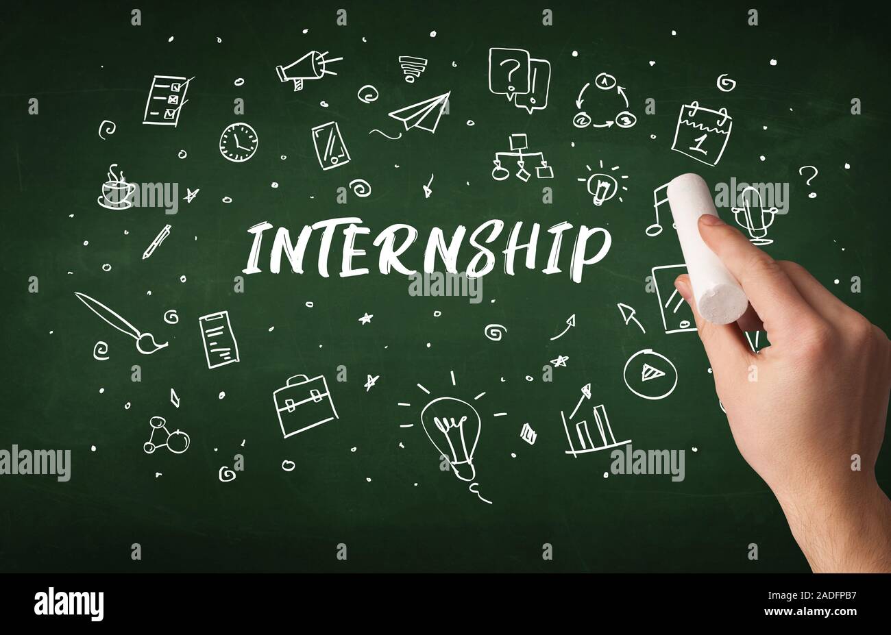 Hand drawing INTERNSHIP inscription with white chalk on blackboard ...