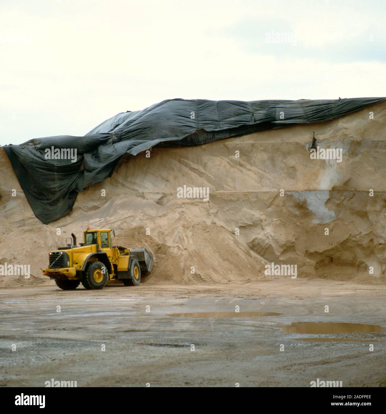 Salt digger digging for rock salt in an open mine. Photographed in ...