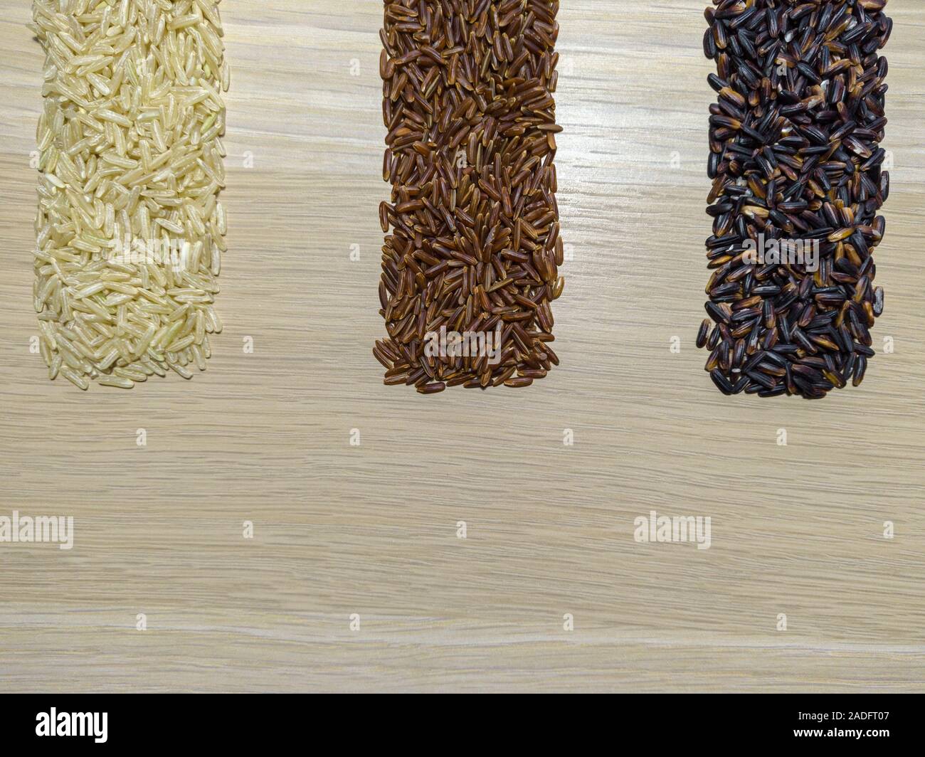 three rows of different types of rice which are of different colours ...