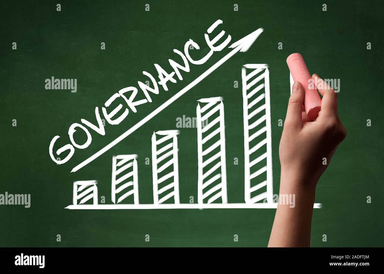 Hand drawing GOVERNANCE inscription with white chalk on blackboard ...