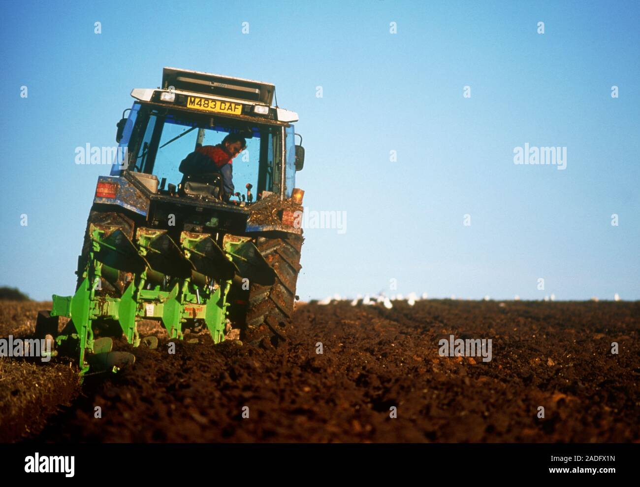 Tractor ploughing field. View of a tractor ploughing a field. Fields ...