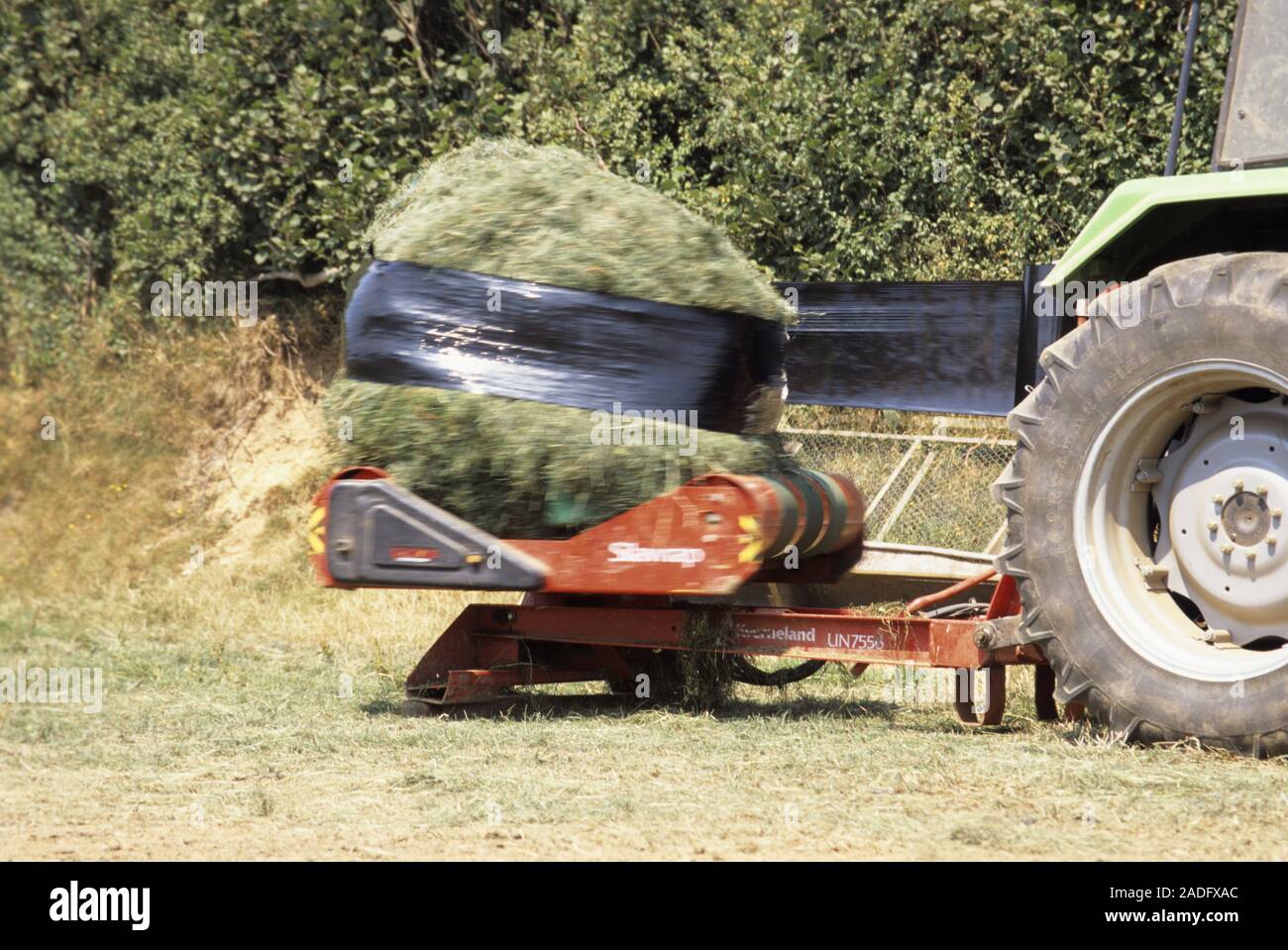 Silage wrapping. Grass being wrapped in polythene. These bales will be ...