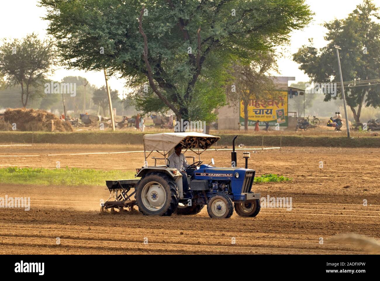 Farmer ploughing a field with a tractor. Photographed in Rajasthan ...