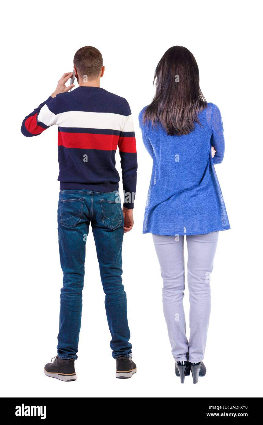 Back view of couple. beautiful friendly girl and guy together. Rear ...