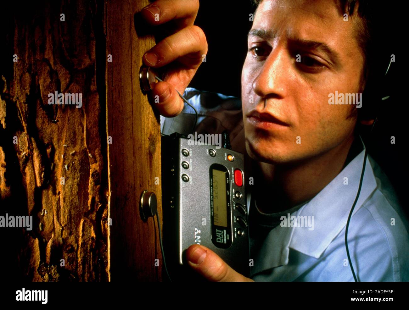 Termite detection. Male technician using an acoustic insect detection ...