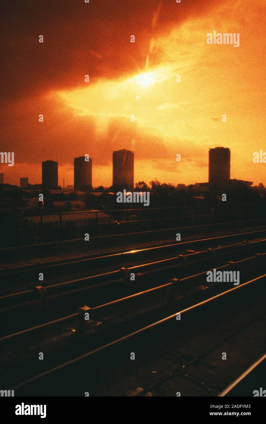 City landscape of railway tracks and tower blocks. Photographed in East ...