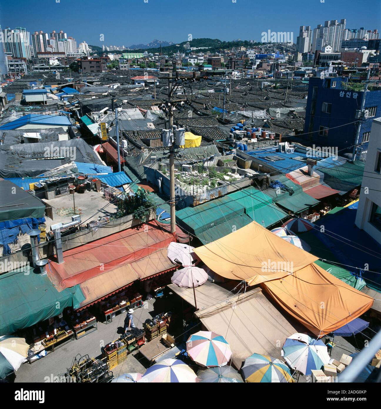 Street market. Aerial view across rooftops of a city with market stalls ...
