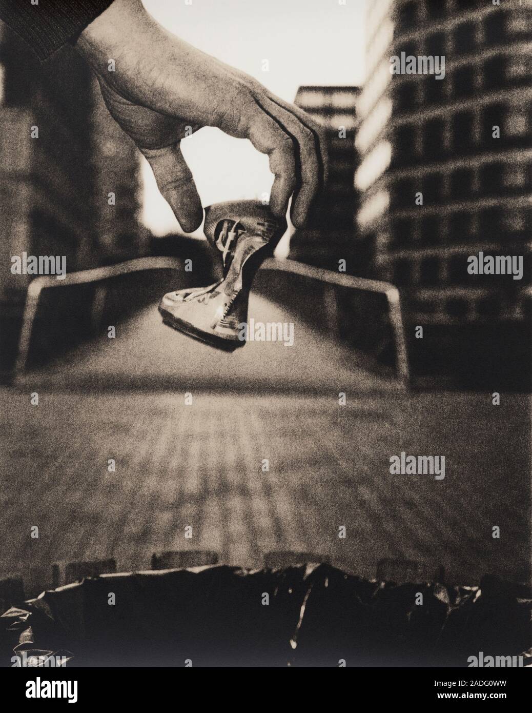 Disposing of litter. Hand dropping an empty soft drink can into a bin ...