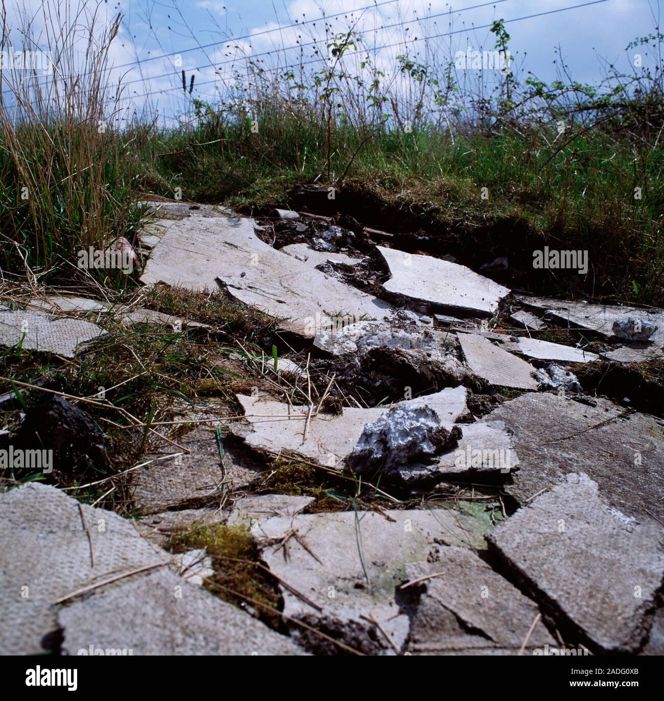 Asbestos landfill site. Inadequately buried pieces of asbestos seen on ...