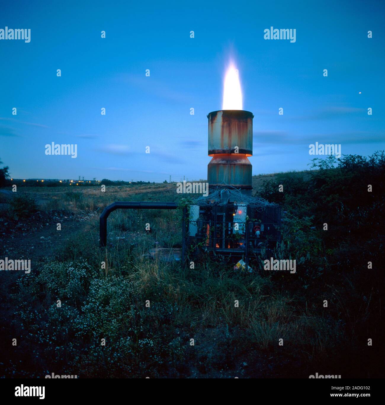 Landfill gas flare. Landfill sites contain organic matter that decays ...