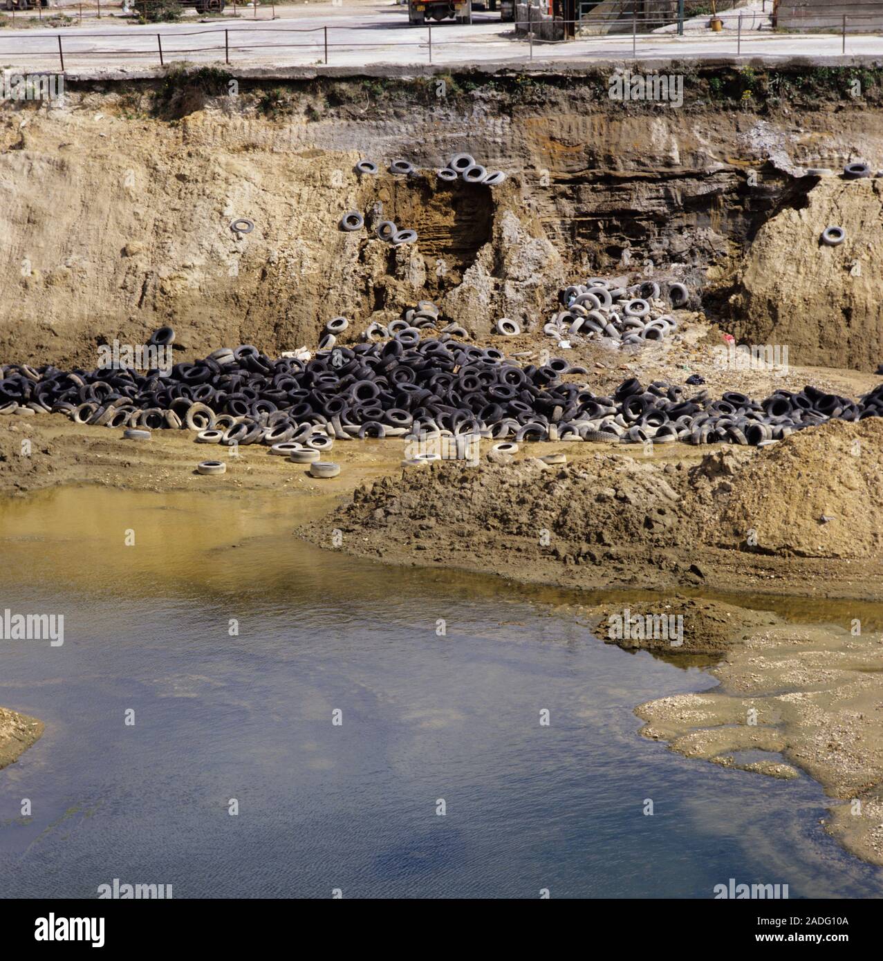 Dumped tyres waiting for burial at a landfill site. Photographed in ...