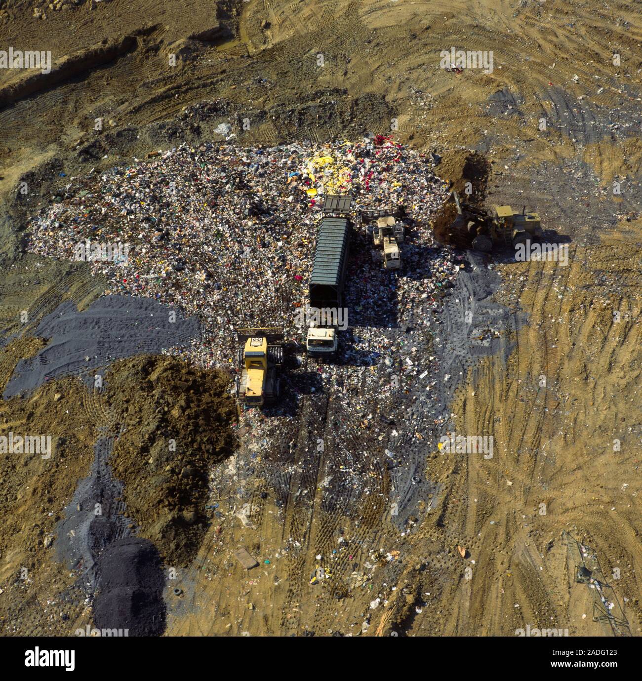 Landfill site. Aerial photograph of trucks dumping waste on a landfill ...