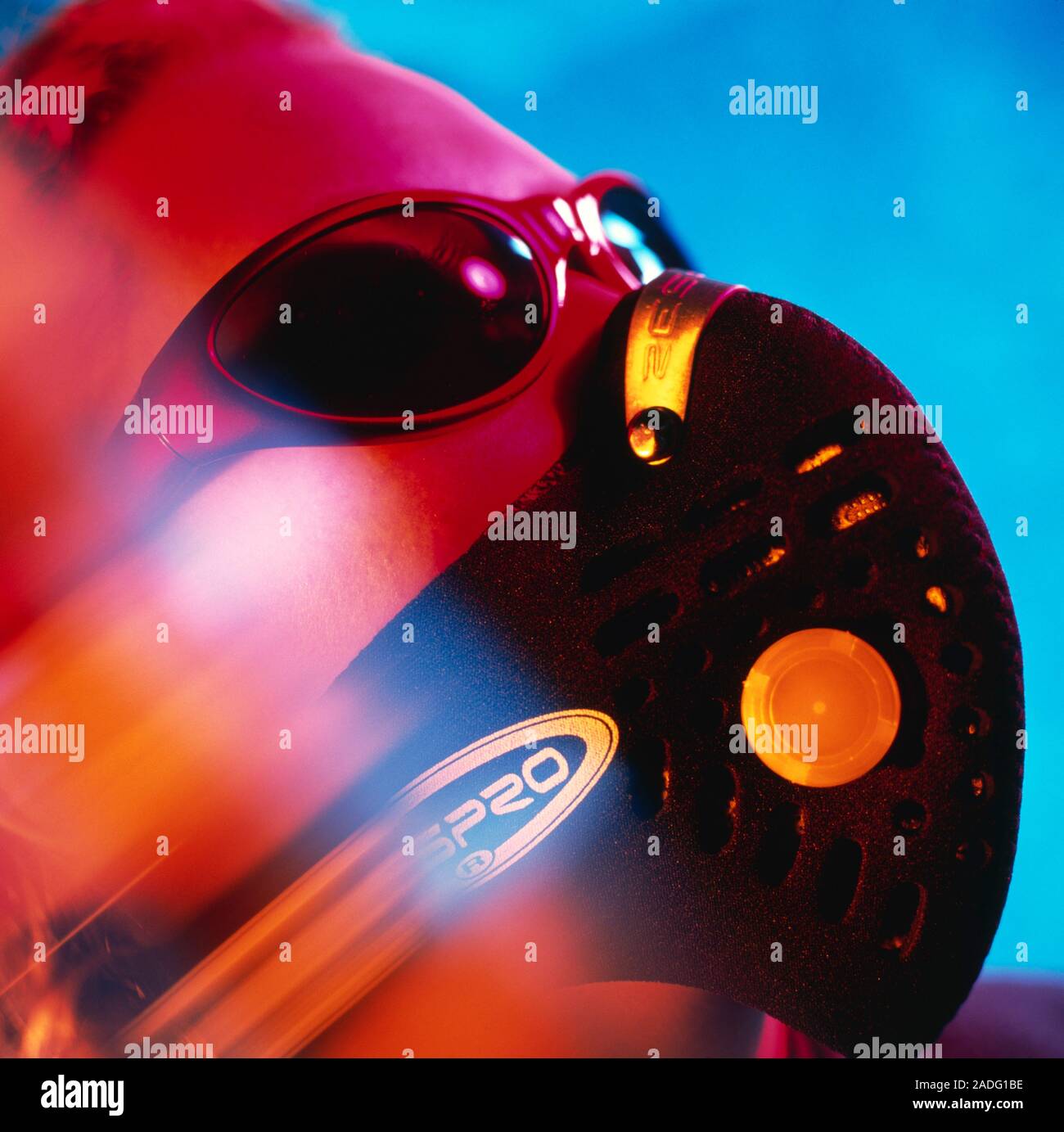 Air pollution mask. Cyclist wearing an air pollution mask. The main ...