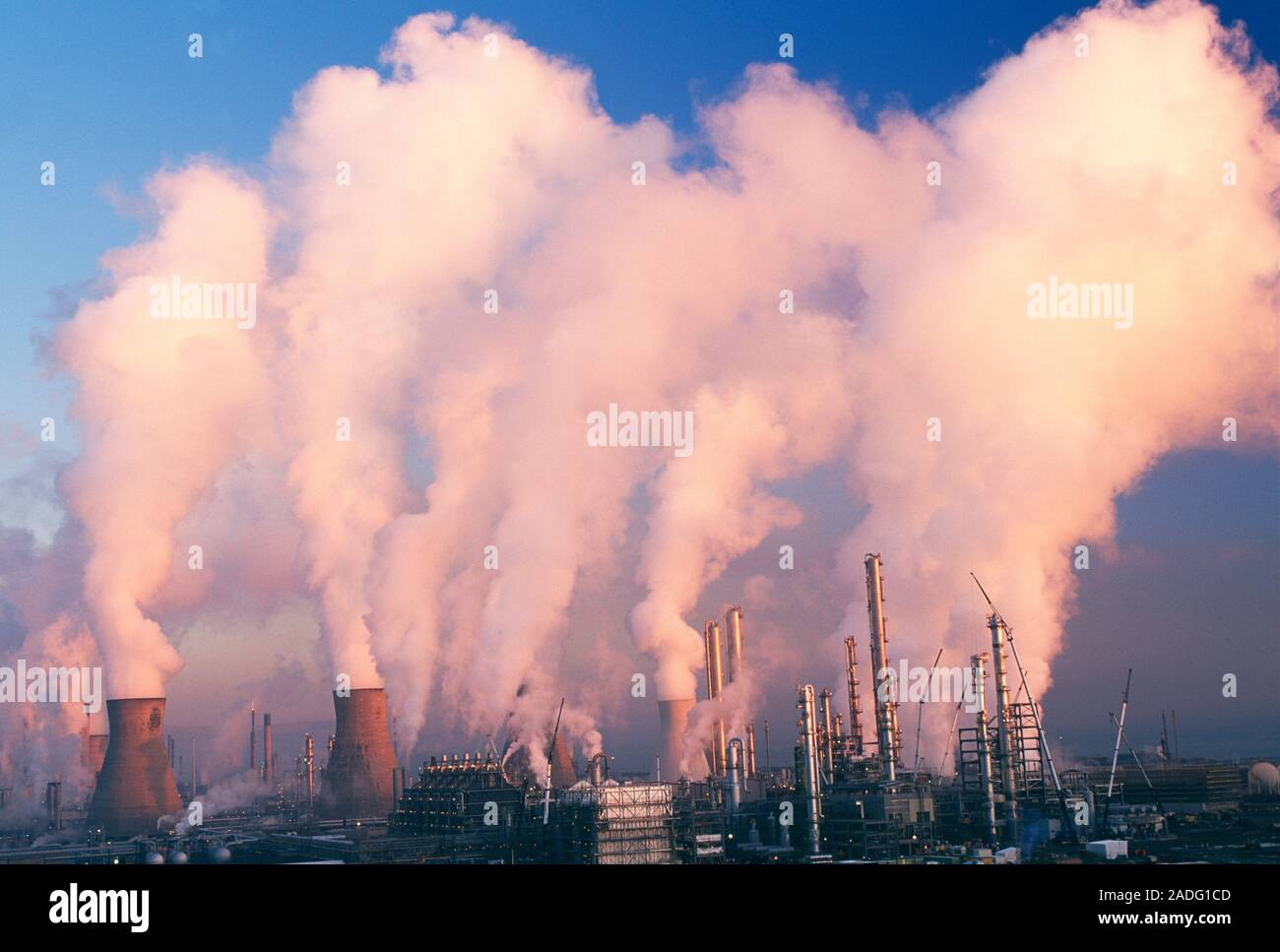 Industrial air pollution. Steam and smoke clouds rising from the ...