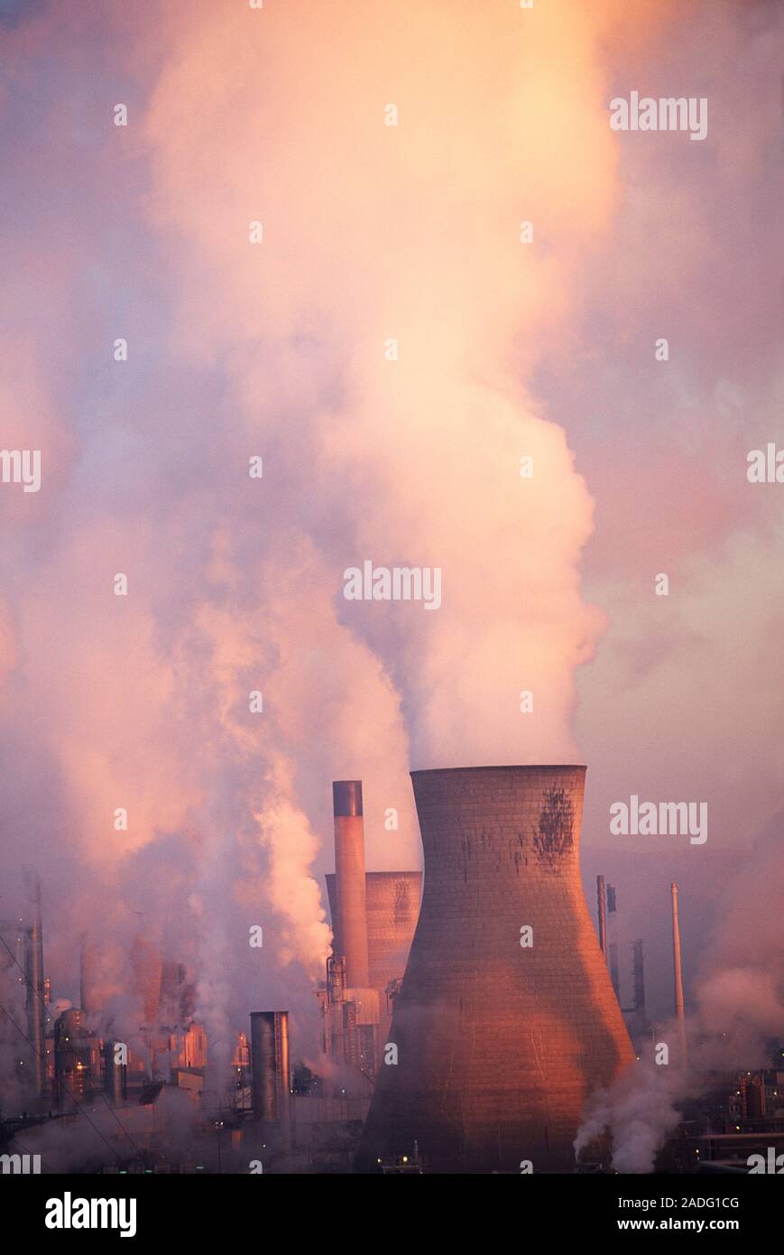 Industrial air pollution. Steam and smoke clouds rising from the ...